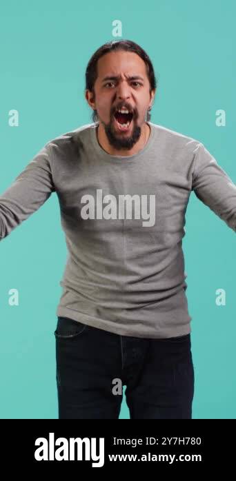 Vertical video Portrait of irate man feeling outraged, yelling at ...