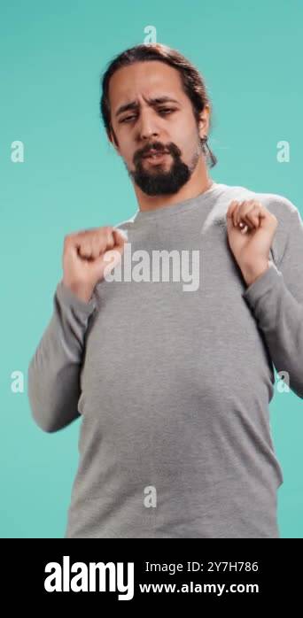 Vertical video Portrait of man stretching his body, experiencing ...