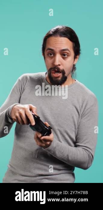 Vertical video Gamer with disappointed look on face after receiving ...