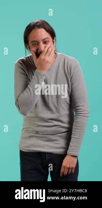 Vertical video Portrait of cheerful man laughing hard, amused by funny ...