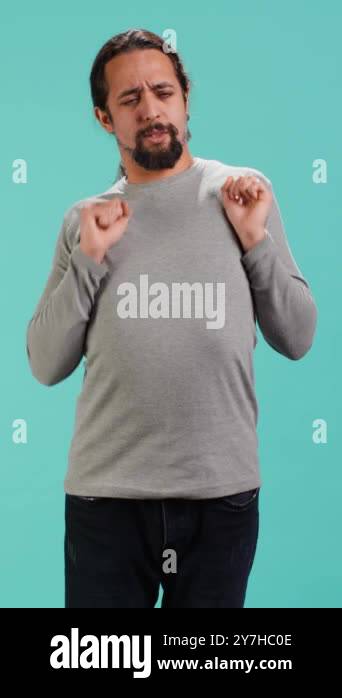 Vertical video Portrait of man stretching his body, experiencing ...