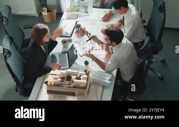 Top down view of skilled engineer team compare between blueprint and ...