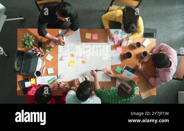 Top down aerial view of diverse business team making scrum task board ...