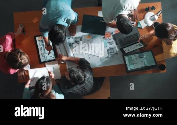 Top down of skilled business people holding tablet an looking at ...