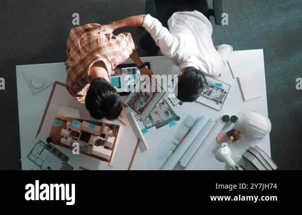 Top down view of skilled business man and colleague design house ...