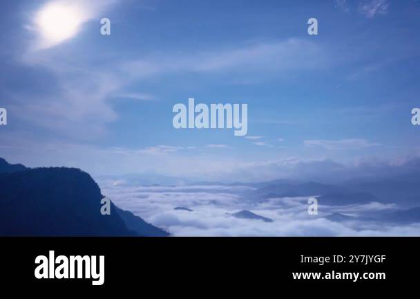 A breathtaking panoramic view of a sea of clouds below a crescent moon and a starry night sky ...