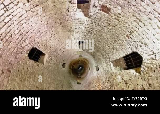 Looking up inside ancient Roman Well with light coming in from top ...