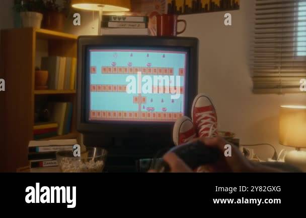 Back view of unrecognizable millennial girl playing arcade platform ...