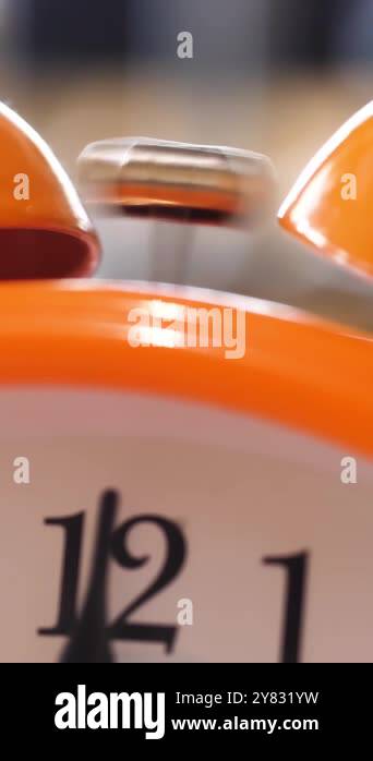 Close up of retro alarm clock going off on blurred background. Stock ...