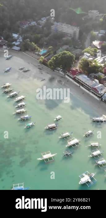 Vertical drone footage captured at sunrise in May showing the city area ...