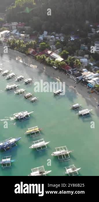 Vertical drone footage captured at sunrise in May showing the city area ...