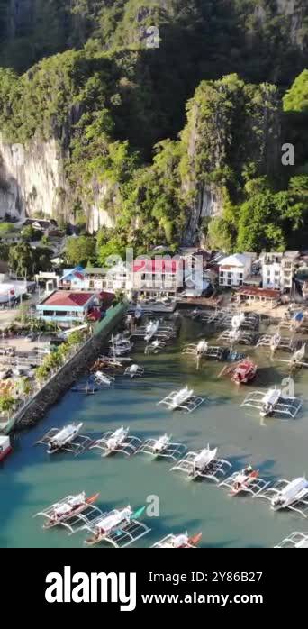 Vertical drone footage captured at sunrise in May showing the city area ...