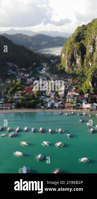 Vertical drone footage captured at sunrise in May showing the city area ...