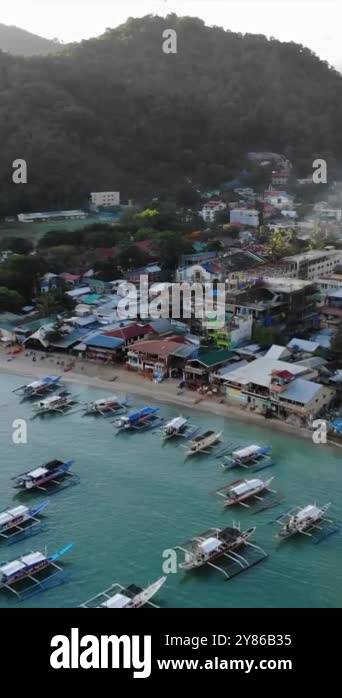 Vertical drone footage captured at sunrise in May showing the city area ...