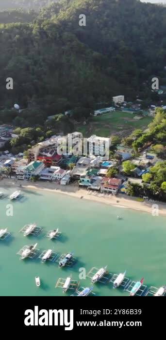 Vertical drone footage captured at sunrise in May showing the city area ...