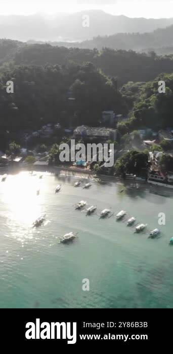 Vertical drone footage captured at sunrise in May showing the city area ...