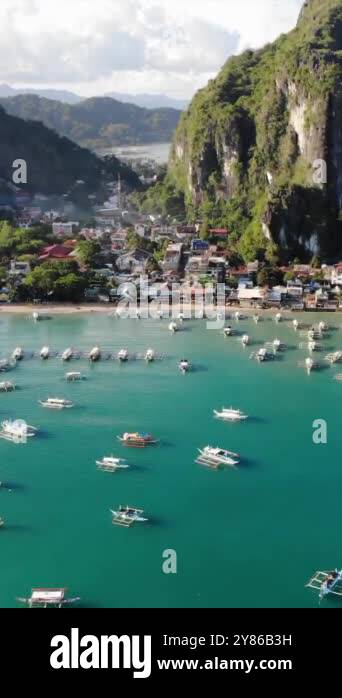 Vertical drone footage captured at sunrise in May showing the city area ...
