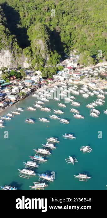 Vertical drone footage captured at sunrise in May showing the city area ...