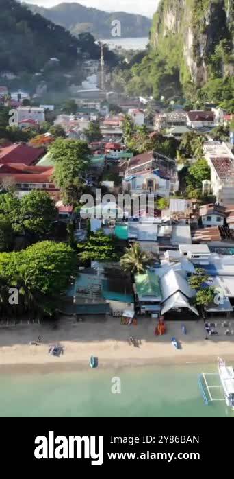 Vertical drone footage captured at sunrise in May showing the city area ...