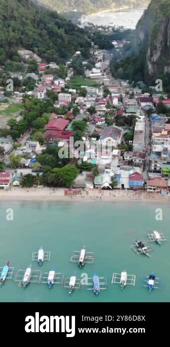 Vertical drone footage captured at sunset in May showing the city area ...