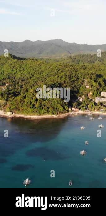Vertical drone footage captured at sunset in May showing the city area ...
