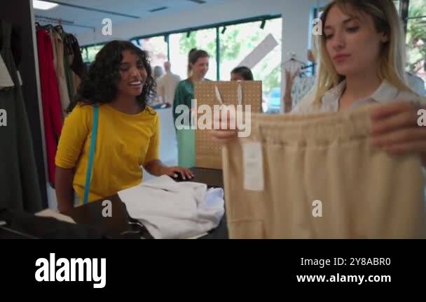 Customer smiles as her items are prepared at the checkout counter in a ...
