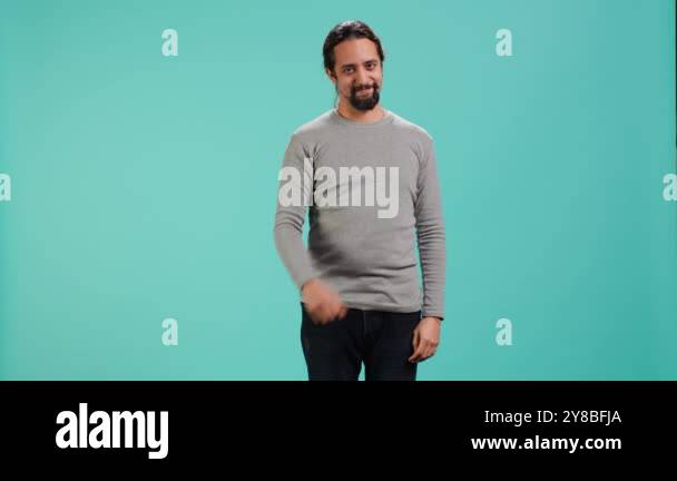 Happy man asking for money with hand gesture, rubbing fingers together ...