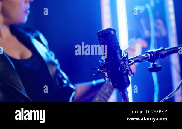 Female grunge vocalist performing in a live concert at nightclub ...