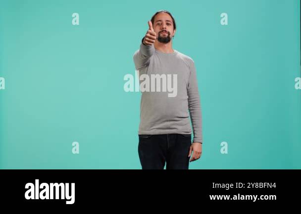 Joyous man showing thumbs up sign gesturing, exulting positive emotion ...
