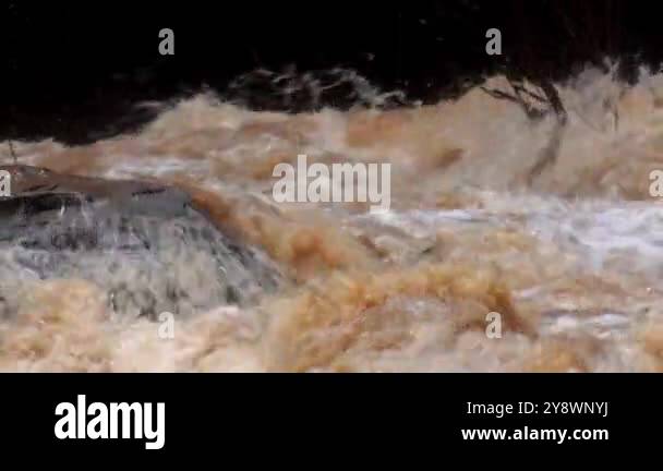 A strong current near a waterfall. Floods flowing in mountain rivers ...