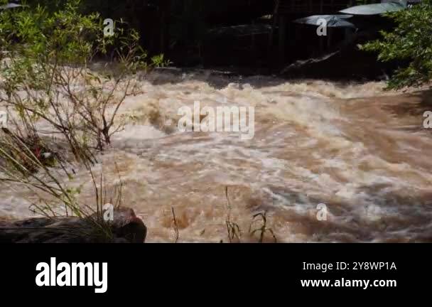 A strong current near a waterfall. Floods flowing in mountain rivers ...