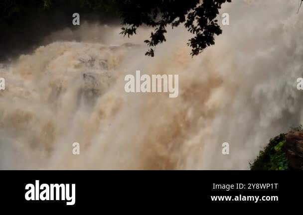 A strong current near a waterfall. Floods flowing in mountain rivers ...