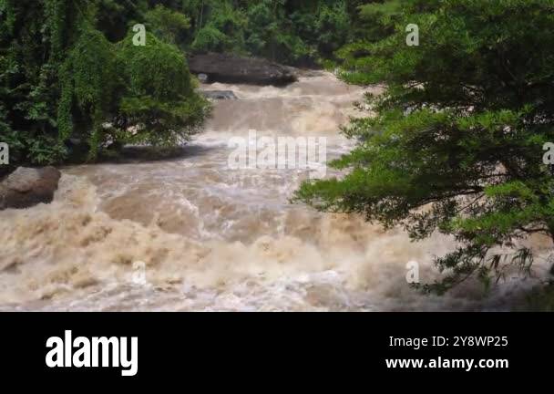 A strong current near a waterfall. Floods flowing in mountain rivers ...