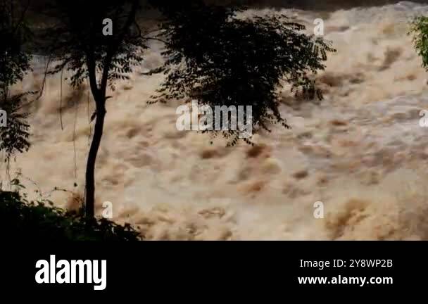 A strong current near a waterfall. Floods flowing in mountain rivers ...