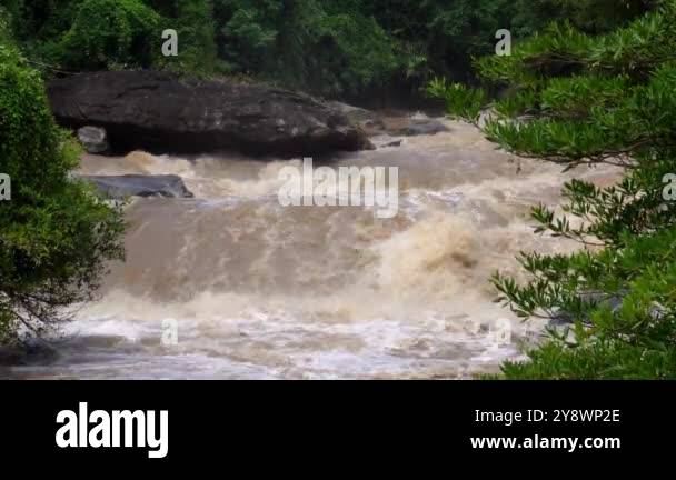 A strong current near a waterfall. Floods flowing in mountain rivers ...