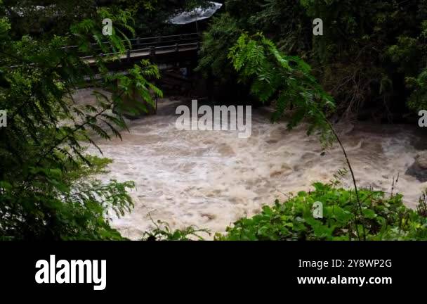 A strong current near a waterfall. Floods flowing in mountain rivers ...
