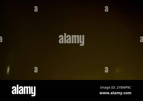 An abstract real lens flare overlay with a soft, cinematic glow against ...