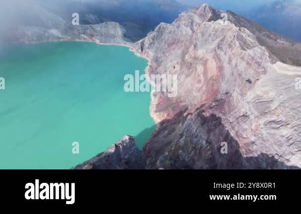 Aerial view of rock cliff at Kawah Ijen volcano with turquoise sulfur ...