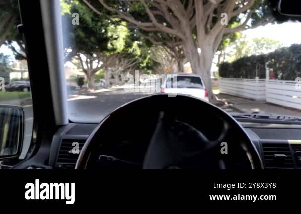 Point of view from inside a car parked on the sidewalk, with hands on ...