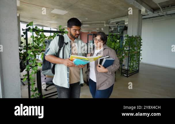 Two Indian students review notes and study materials in preparation for ...