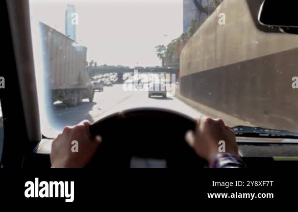 Point of view from inside a car driving behind a large truck on a city ...