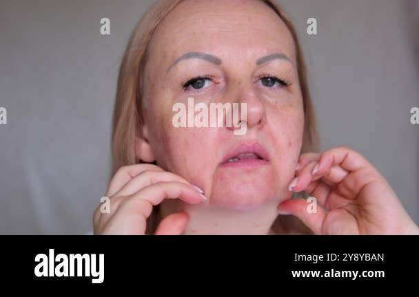 aging facial skin Upper face close up shot of sad elderly mature lady ...
