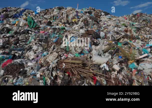 A large landfill is filled with an array of discarded materials ...