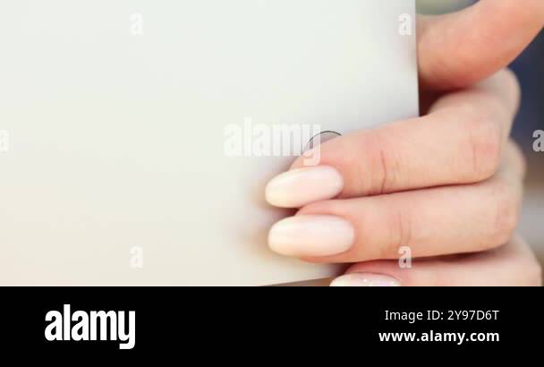 Pressing the power button on a white device. Turning on the monitor and ...