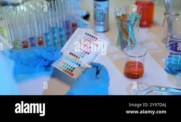Laboratory assistant analyzes a color chart in science laboratory ...