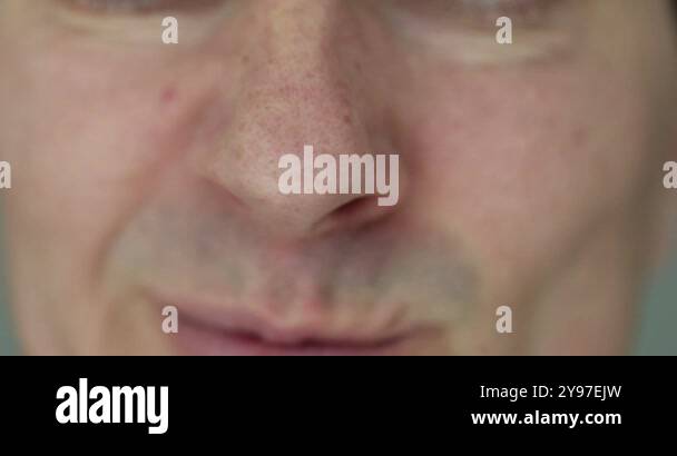 Male face makes funny faces moving mouth from side to side. Man actor ...