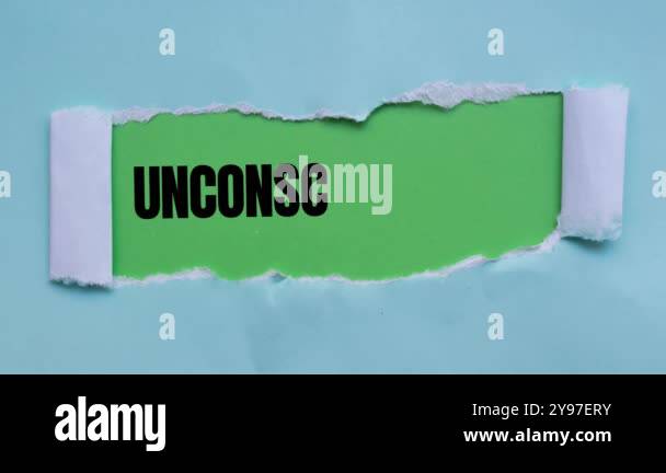 Unconscious bias message writing on ripped torn blue paper on green background. Conceptual ...