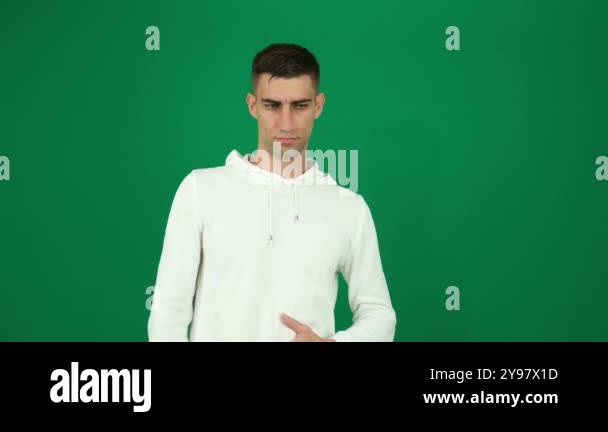 emotions of a handsome man guy on a green background chromakey close-up ...