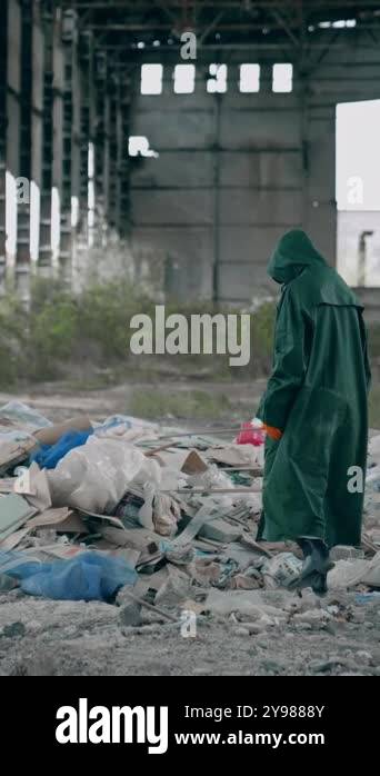 Man in protective suit and respirator in abandoned building. Ecologist ...