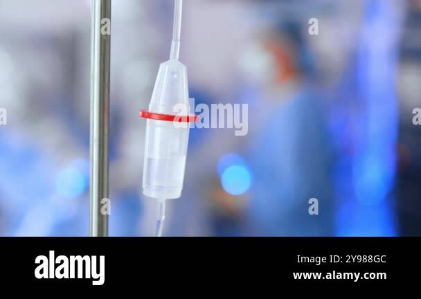 Saline solution dripping inside the reservoir of a drop counter. Iv ...